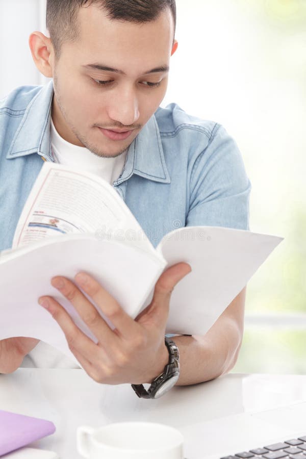Young Man Enjoy and Focus Reading a Book Stock Photo - Image of gadget ...