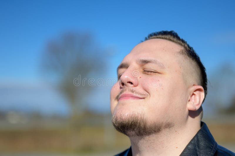 Young Man Enjoying the Sun in a Park with Eyes Closed Stock Image ...