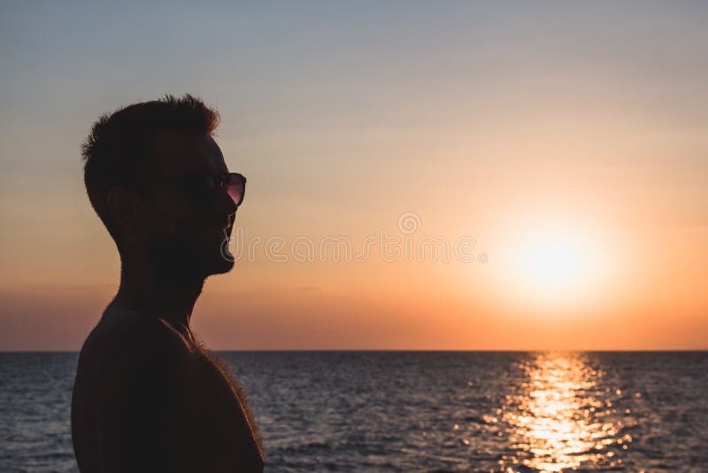 Young Man Enjoying Sunset by the Sea Stock Image - Image of scenic ...