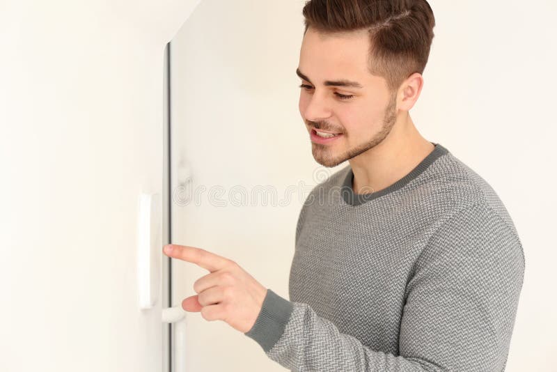 Young Man Entering Code on Security Alarm System, Indoors Stock Image ...