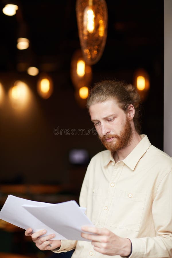 Young Man Examining the Documents Stock Photo - Image of paper, serious ...