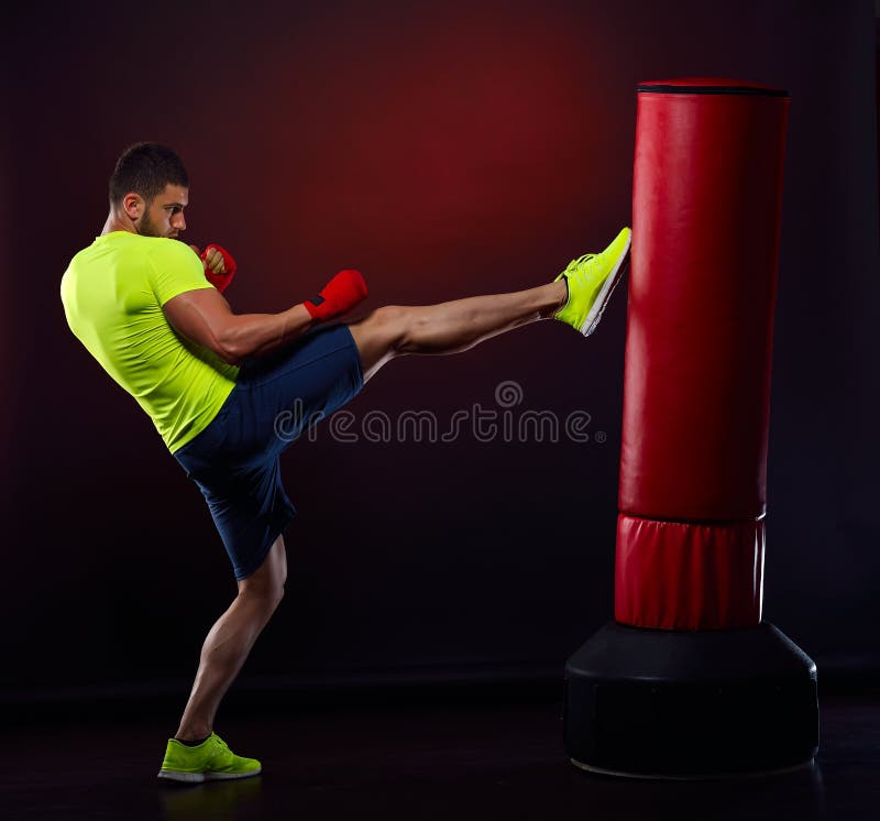 Young Man Exercising Bag Boxing in Studio Stock Photo - Image of ...