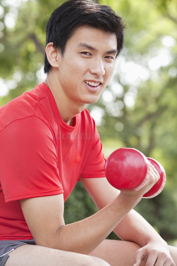 Young Man Exercising with Dumbbell Stock Photo - Image of body ...