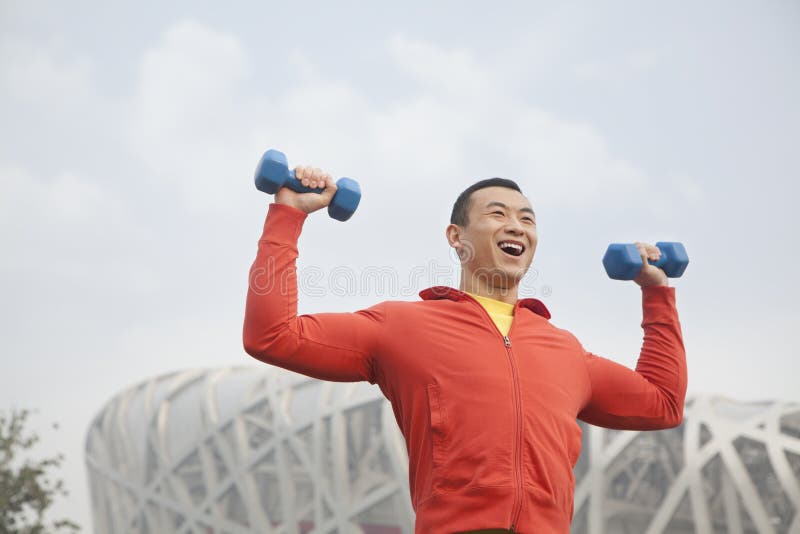 Young Man Exercising with Dumbbells in Park, Beijing Stock Image ...