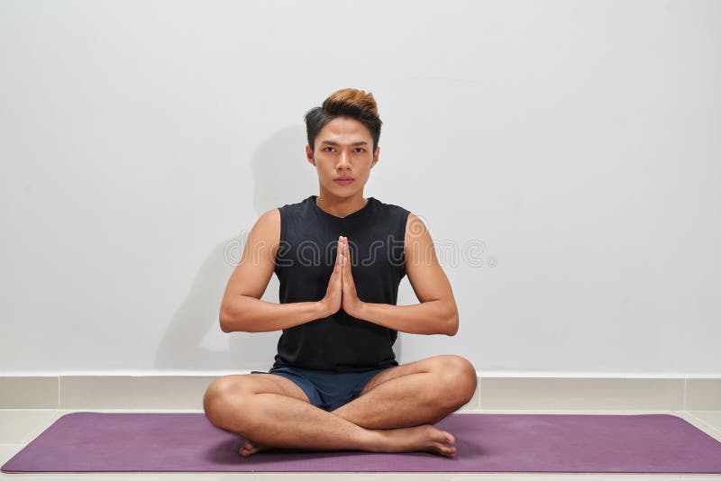 Young Man Exercising on Exercise Mat, Indoors Stock Photo - Image of ...