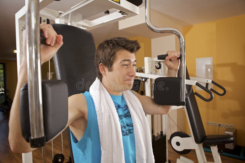 A Young Man Exercising at Gym Stock Image - Image of keeping, person ...
