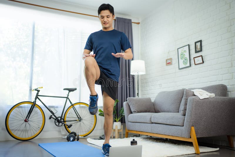 Young Man Exercising at Home. he Was Running in the Living Room Stock ...