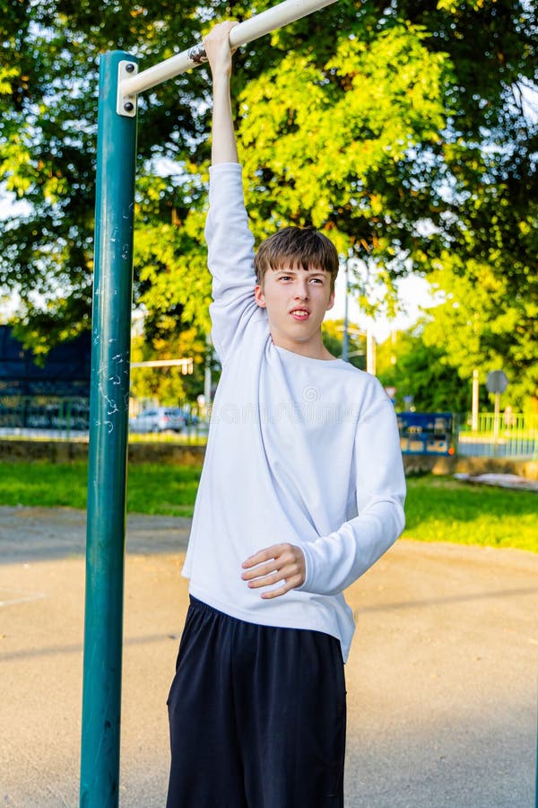 Young Man Exercising on Parallel Bars at a Park on a Sunny Day Stock ...