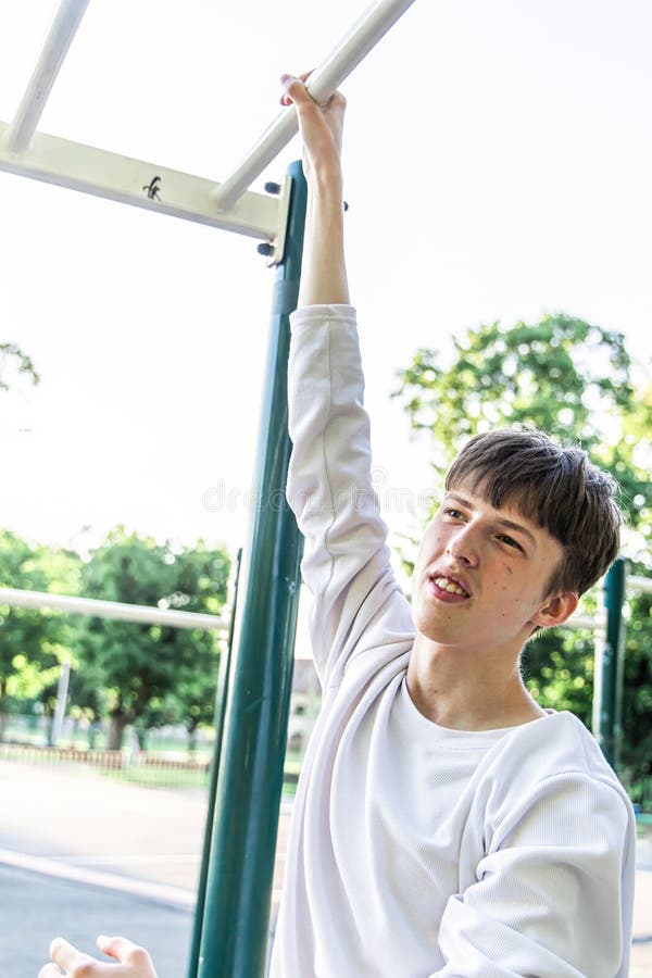Young Man Exercising on Parallel Bars at a Park on a Sunny Day Stock ...