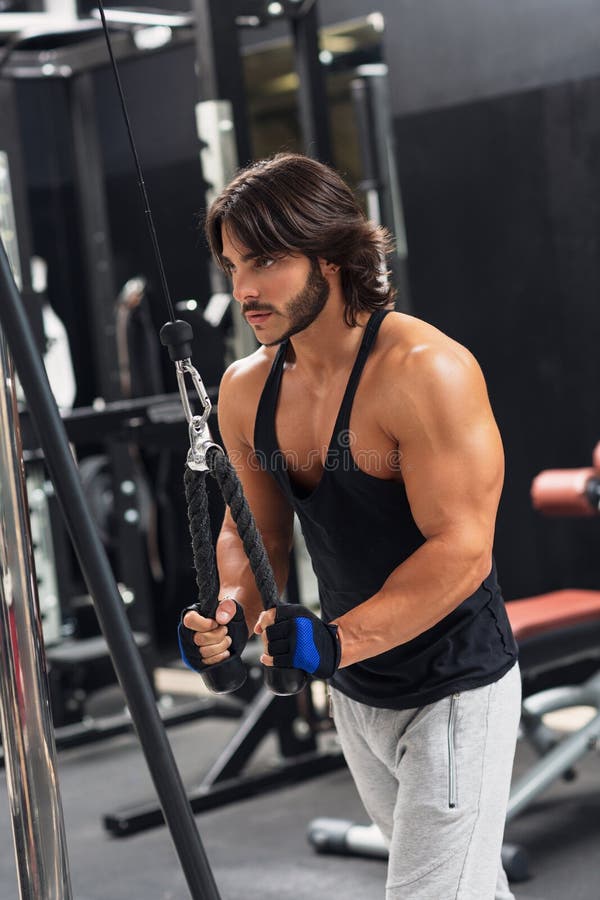 Young Man Exercising Triceps Pulldown at the Gym Stock Image - Image of ...
