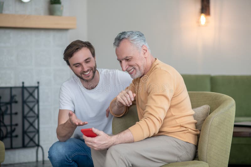 Young Man Explaining His Dad How To Use a New Smartphone Stock Photo ...