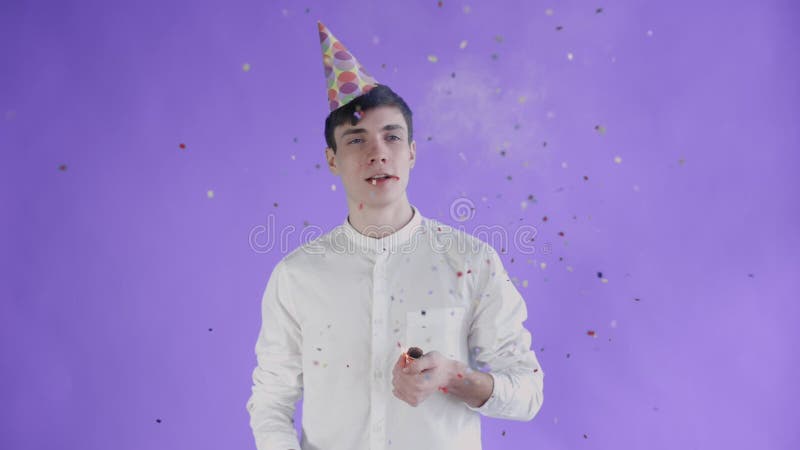 Confetti Was Thrown at the Young Man on a Purple Background. Stock ...