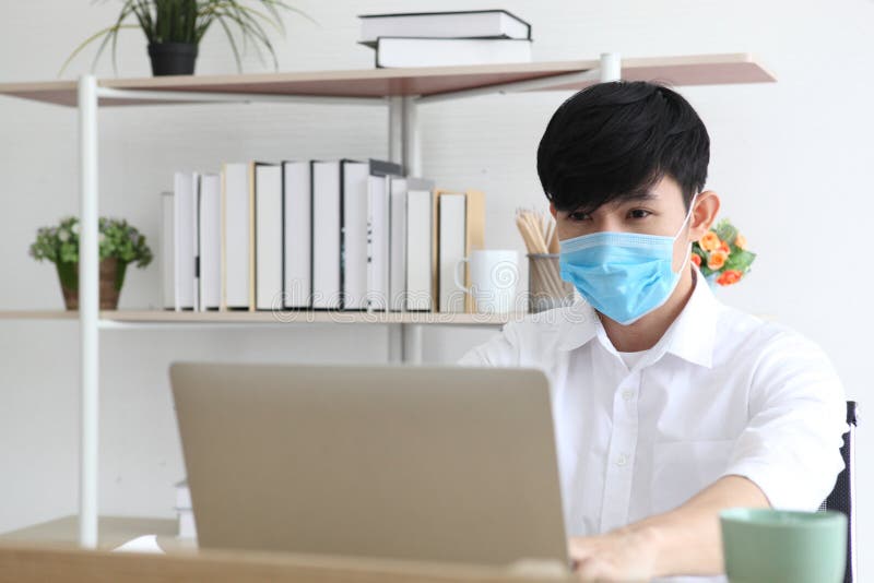 Young Man with Face Mask Back at Work in Office after Lock Down Stock ...