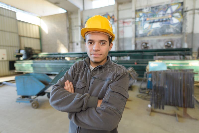 Young man in factory stock image. Image of industry - 172607621