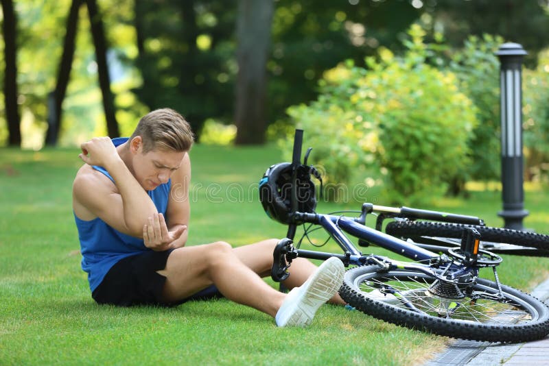 Young Man Fallen Off His Bicycle in Park Stock Photo - Image of fallen ...