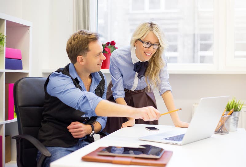 Young Man and Female Colleagues Working Together Stock Photo - Image of ...