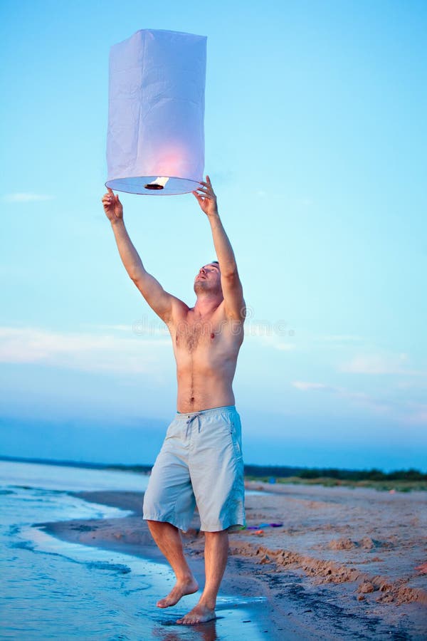 A Young Man with a Fire Lantern Stock Photo - Image of person, ceremony ...