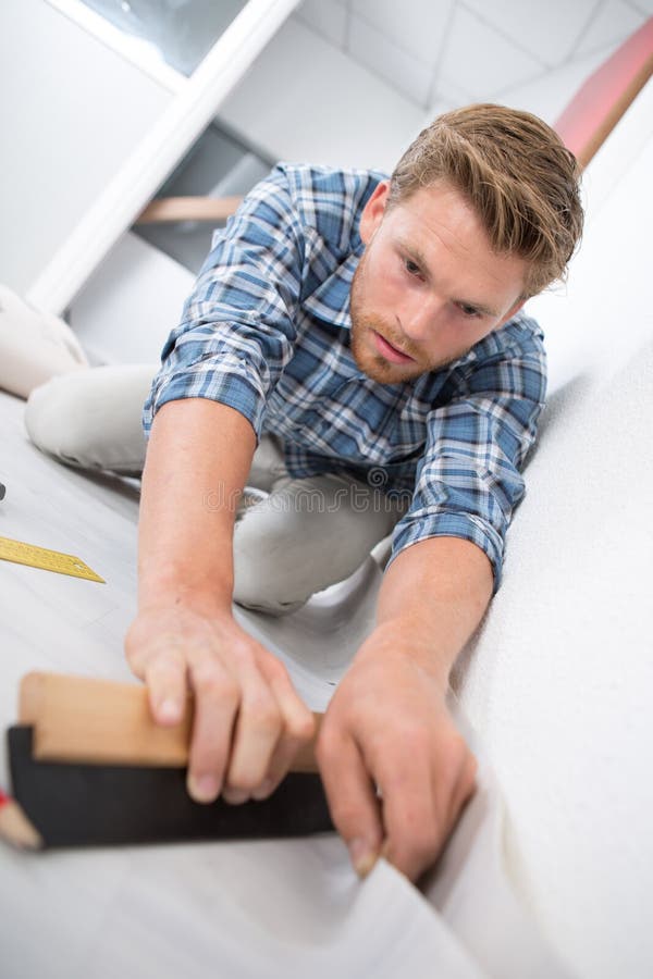 Young Man Fitting Carefully Roll Carpet Stock Image - Image of living ...