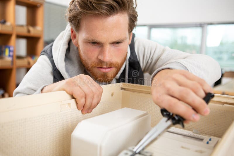 Young man fixing box stock photo. Image of electric - 212233578