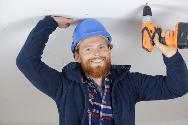 Young Man Fixing Ceiling Using Electrical Screwdriver Stock Image ...