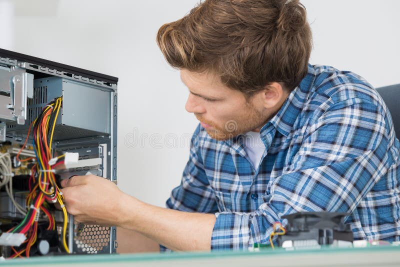 Young man fixing computer stock image. Image of server - 117486559
