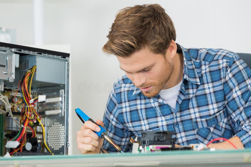 Young man fixing computer stock image. Image of support - 117899521