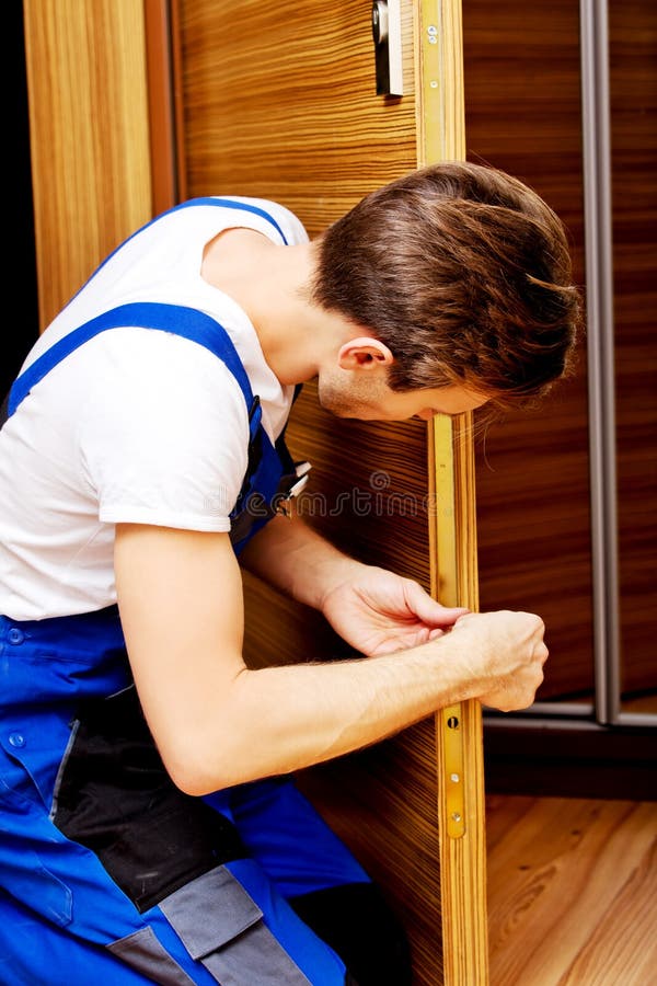 Young Man Fixing the Door with Screwdriver Stock Image - Image of ...