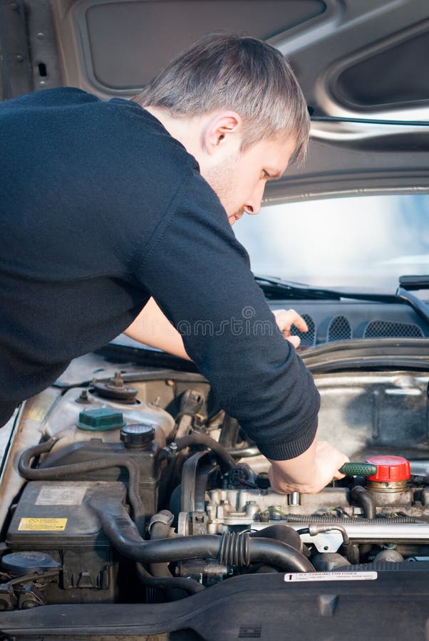Young man fixing his car stock image. Image of motor - 26470369