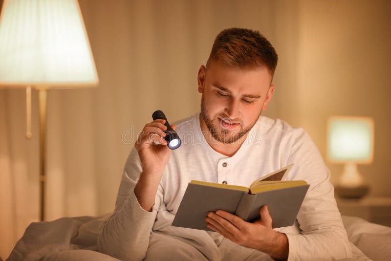 Young Man with Flashlight Reading Book Stock Image - Image of male ...