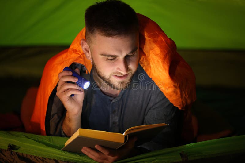 Young Man with Flashlight Reading Book Stock Image - Image of inside ...