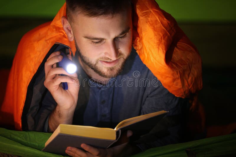 Young Man with Flashlight Reading Book Stock Photo - Image of green ...