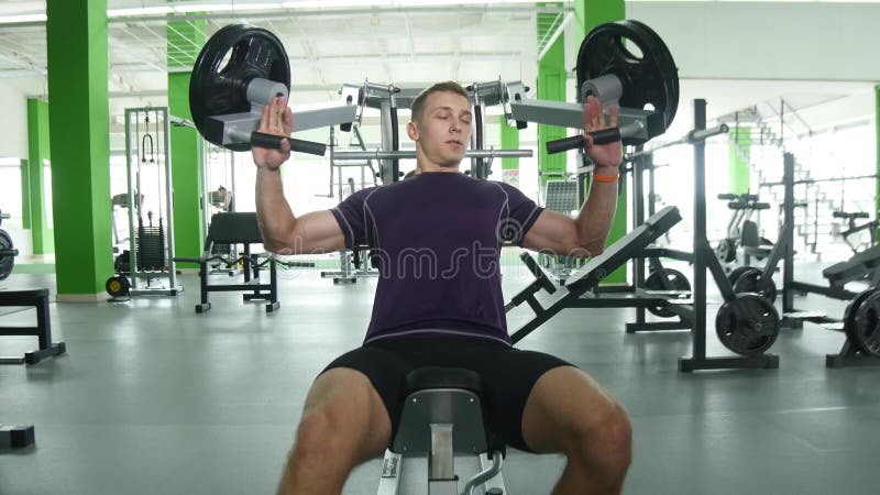 Young Man Flexing Chest Muscles on Gym Machine Stock Photo - Image of ...