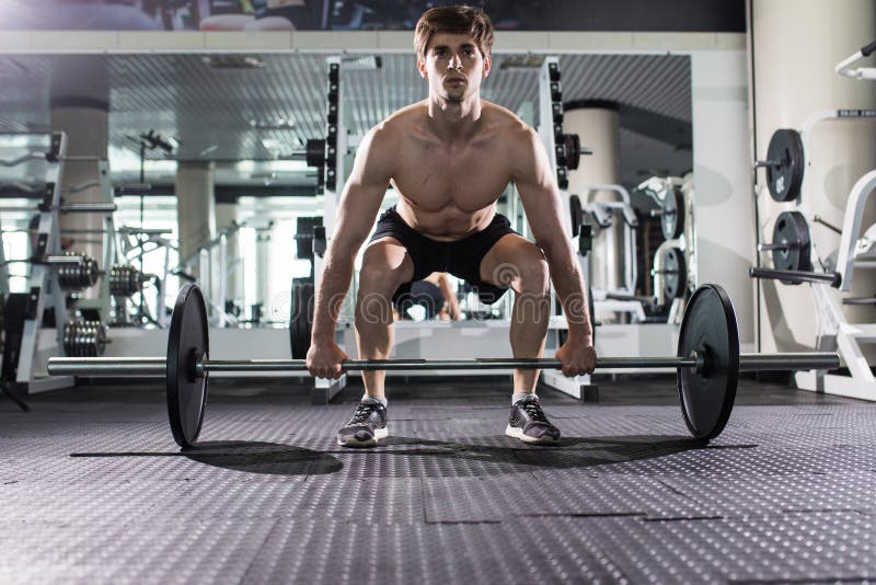 Young Man Flexing Muscles with Barbell in Gym. Sport Stock Photo ...