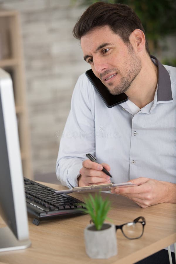 Young Man in Formalwear Making Notes while Talking on Phone Stock Image ...