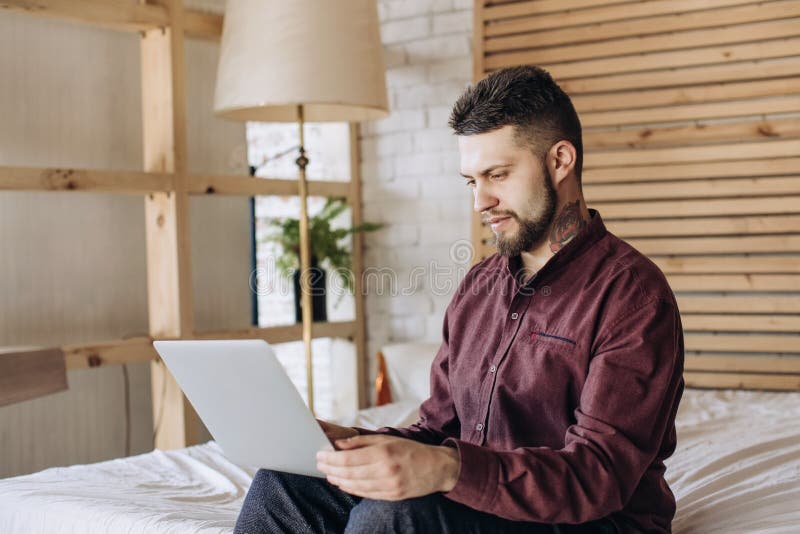 Young Man Freelancer Working on Laptop Computer in Bed Stock Image ...