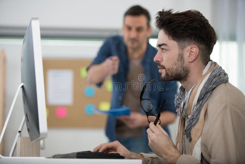 Young Man Frowning while Using Computer Stock Photo - Image of profile ...