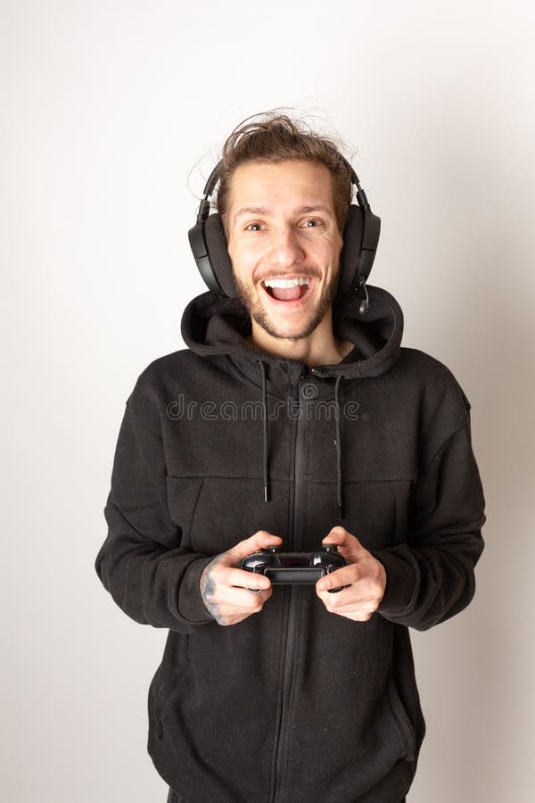Young Man with a Gaming Headset and Controller Having Fun Playing a ...