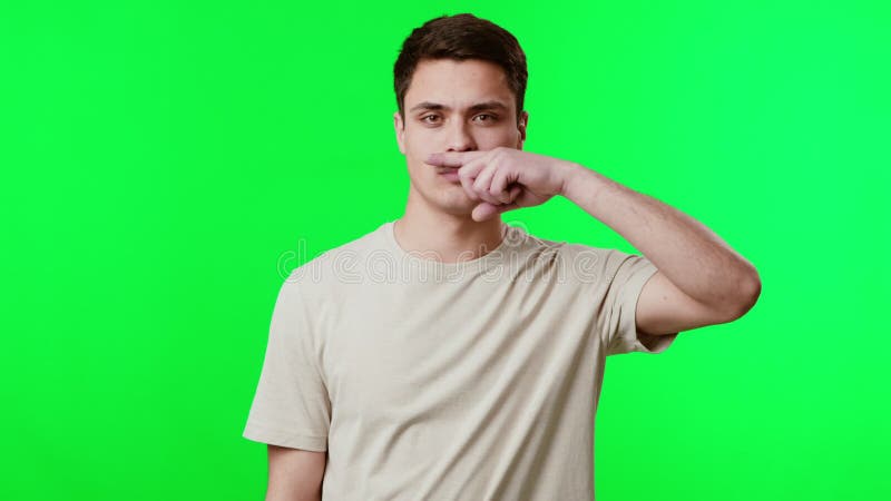 Young Man Gestures Thoughtfully in Front of Green Screen Backdrop Stock ...