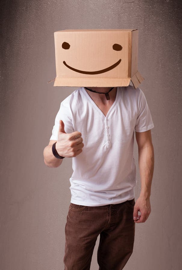 Young Man Gesturing with a Cardboard Box on His Head with Smiley Face ...