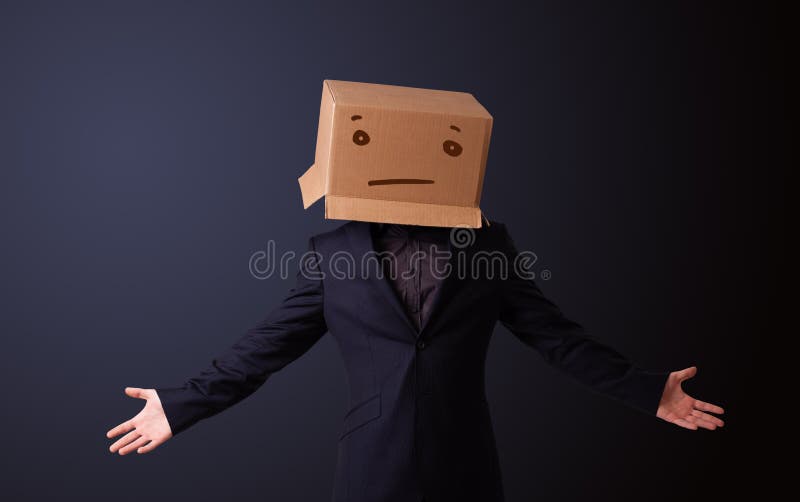 Young Man Gesturing with a Cardboard Box on His Head with Straight Face ...