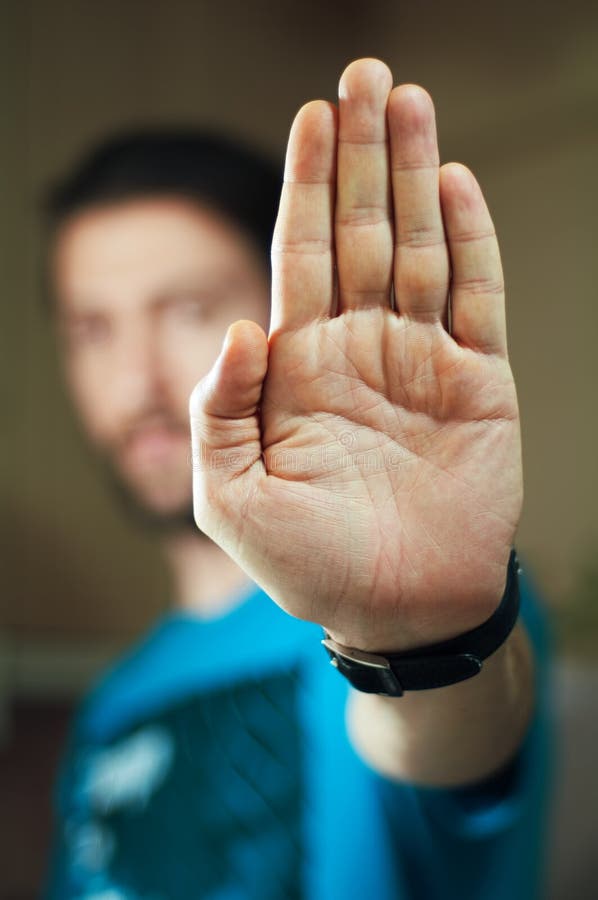 Young Man Gesturing Stop with His Hand Stock Photo - Image of defocused ...