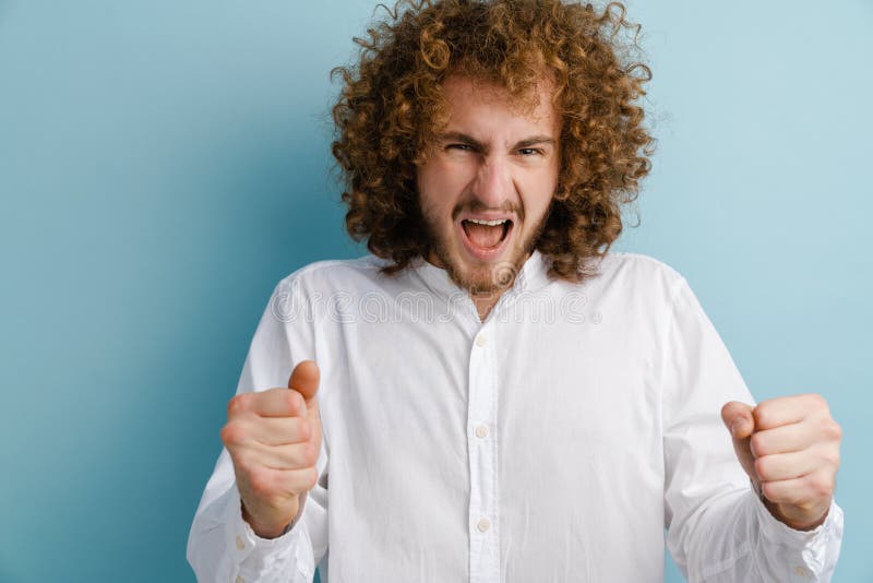 Young Man with Ginger Curly Hair Gesturing and Screaming at Camera ...