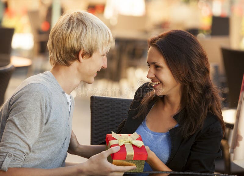 The Young Man Gives a Gift To a Young Girl in the Cafe and they Stock ...