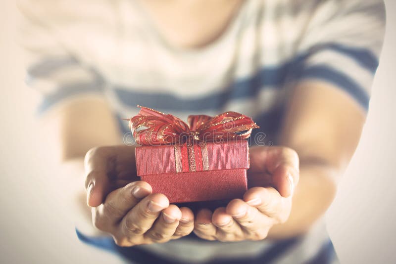 Young Man Giving and Presenting a Gift To Someone. Stock Photo - Image ...