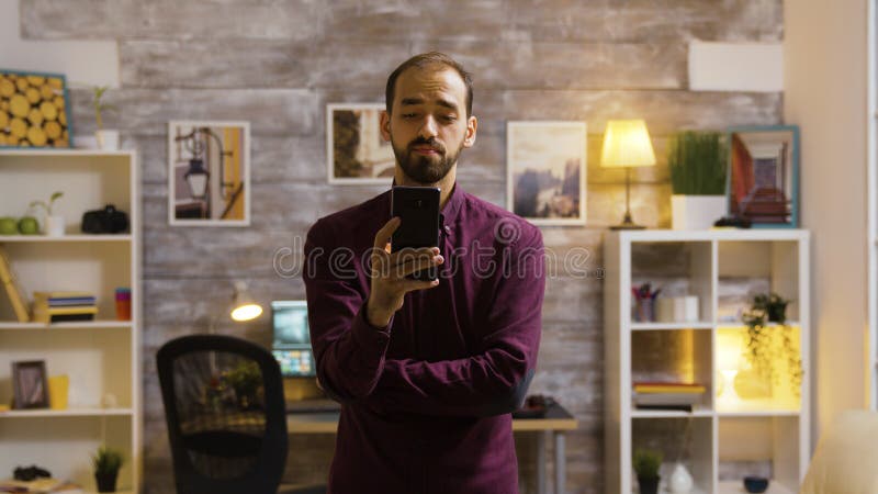 Young Man Giving a Voice Command To His Smart Light Application Stock ...