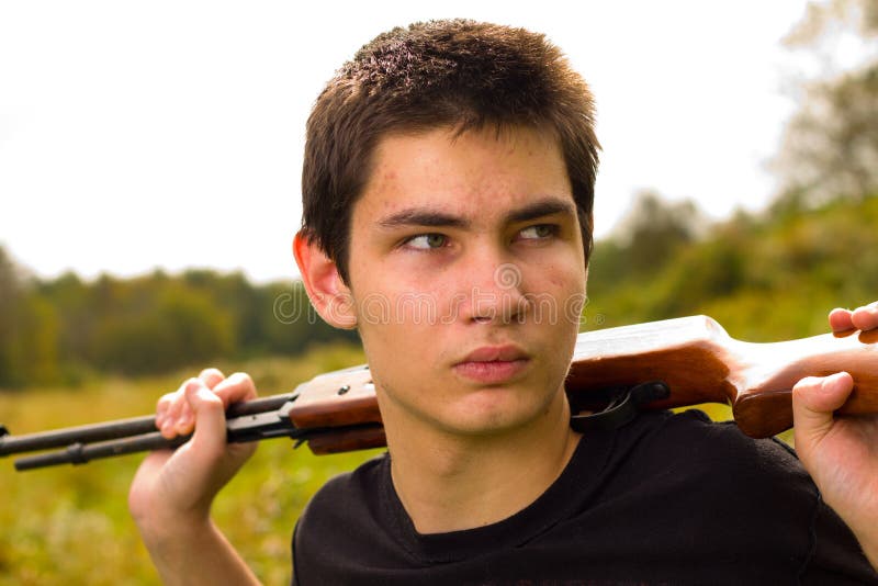 Young Man with Gun or Rifle Stock Image - Image of barrel, field: 21307903