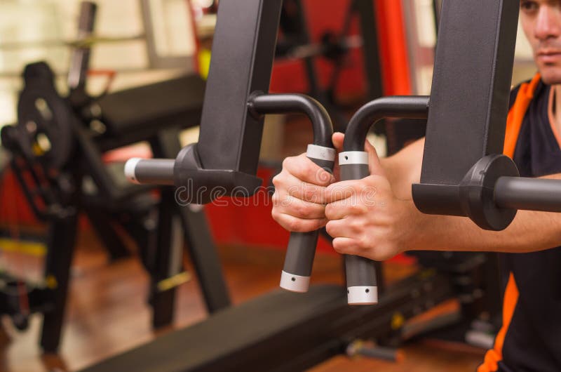 Young Man in the Gym and Exercising Back on Machine Stock Image - Image ...
