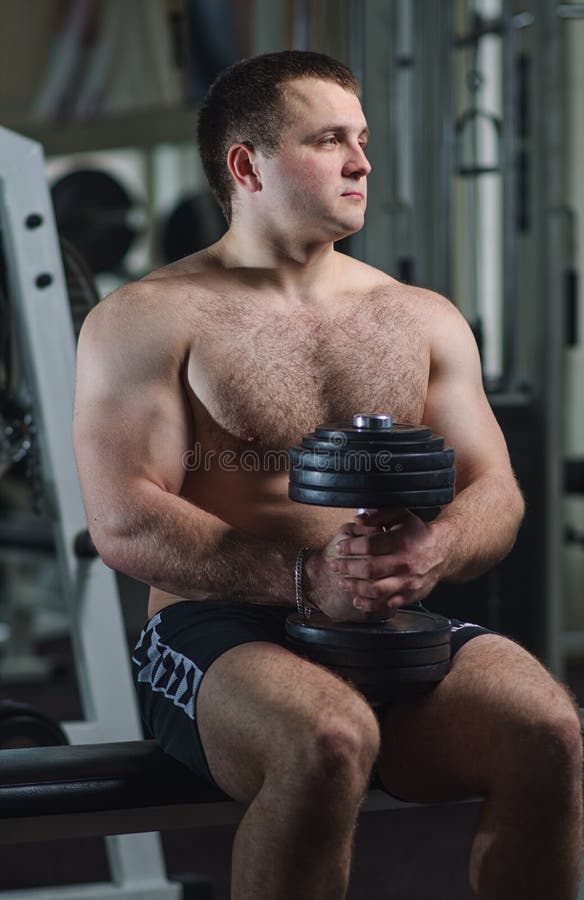Young man at the gym stock photo. Image of dumbbell, bodybuilder - 54730070