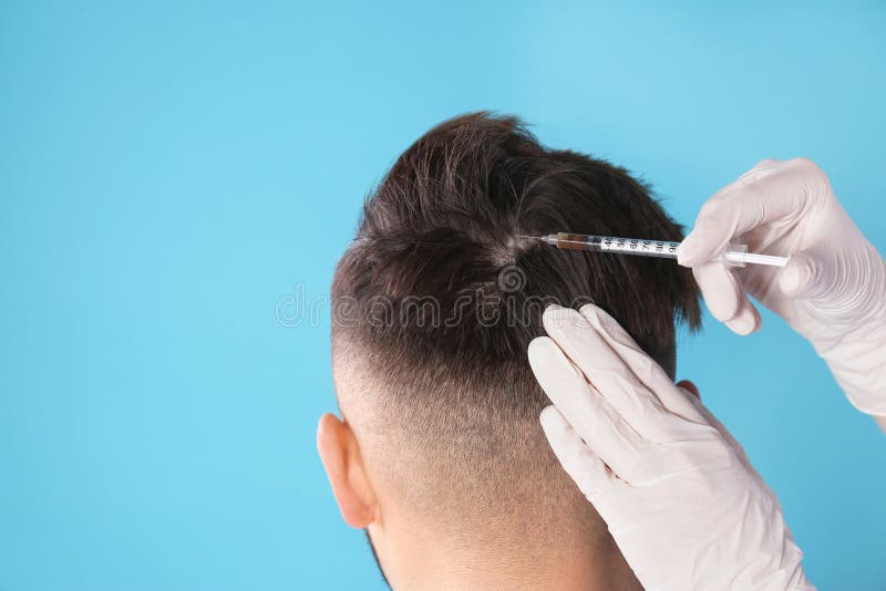 Young Man with Hair Loss Problem Receiving Injection on Color ...