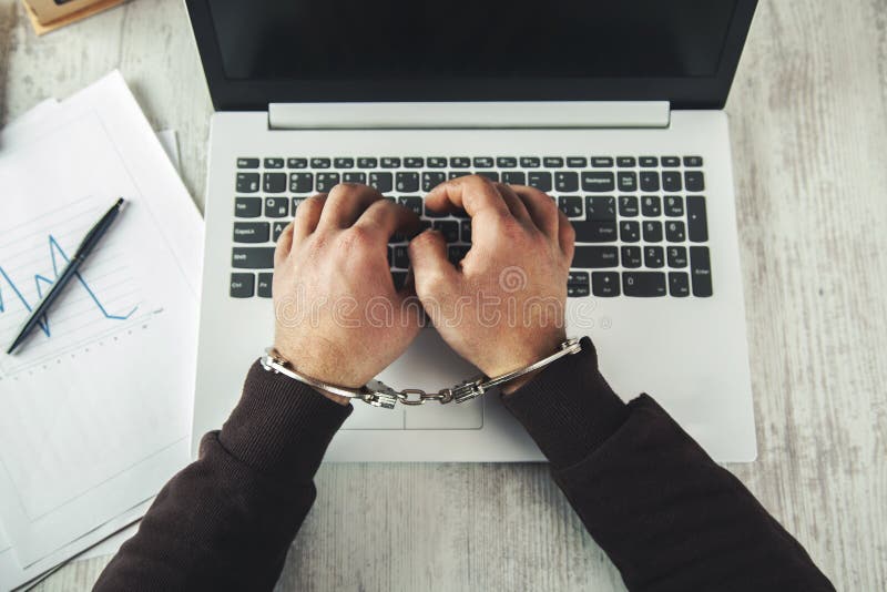 Handcuffs on Computer on Table Stock Photo - Image of keyboard, hacker ...